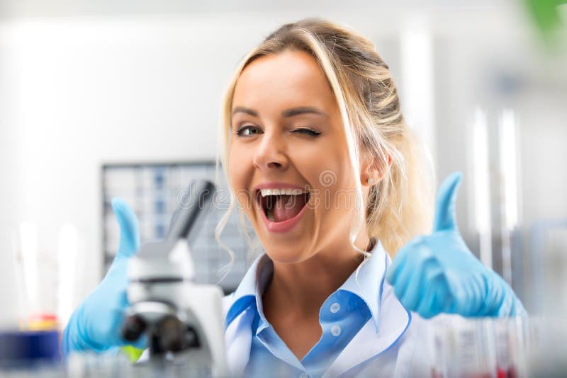 Young Attractive Smiling Woman Scientist is Happy with Her Work Stock ... Young Attractive Smiling Woman Scientist is Happy with Her Work Stock ...