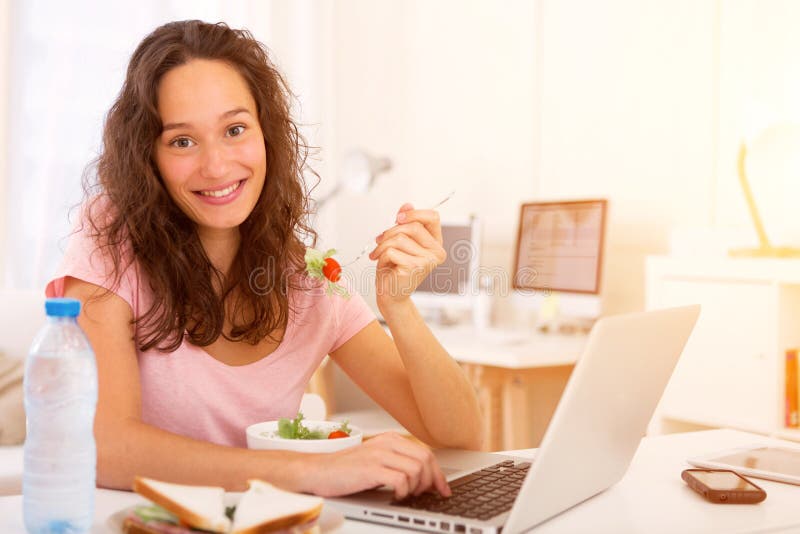 Young Attractive Student Eating while Working Stock Image - Image of ...