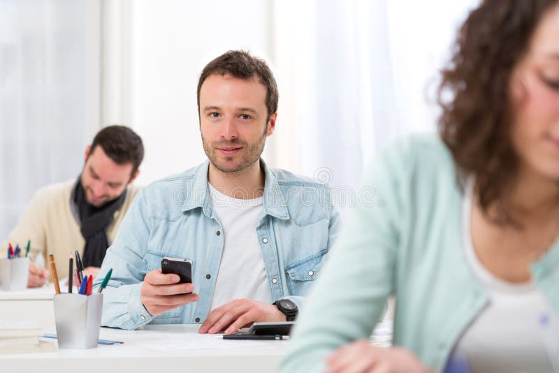 Young Attractive Student Using His Mobile during Classes Stock Photo ...