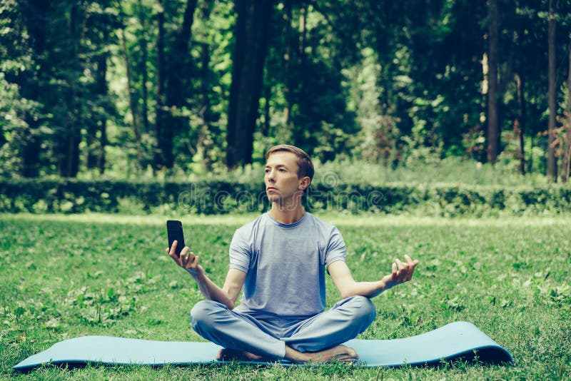 Young Attractive White Man Learns To Meditate in the Park in Front of ...