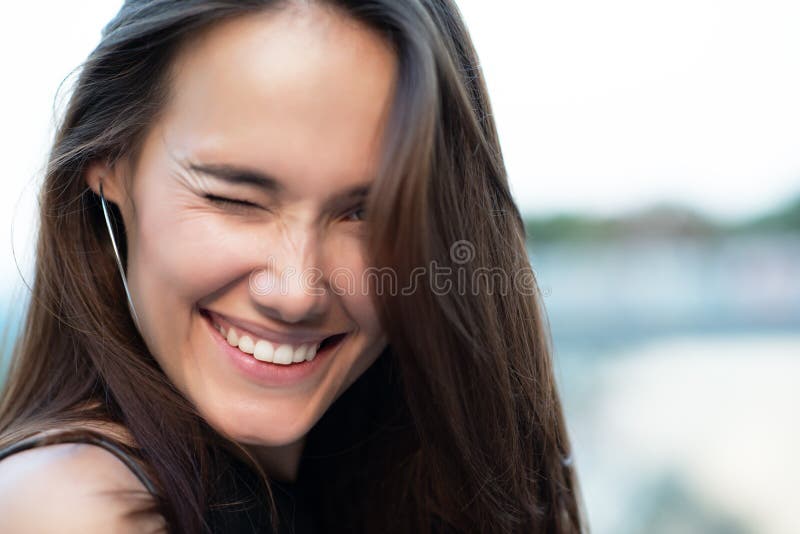 Young Attractive Woman With Perfect Smile Winks At Camera Summer
