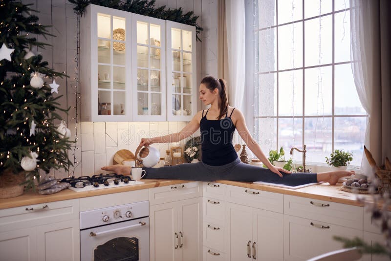Young Attractive Woman Practicing Yoga at Kitchen Stock Photo - Image ...
