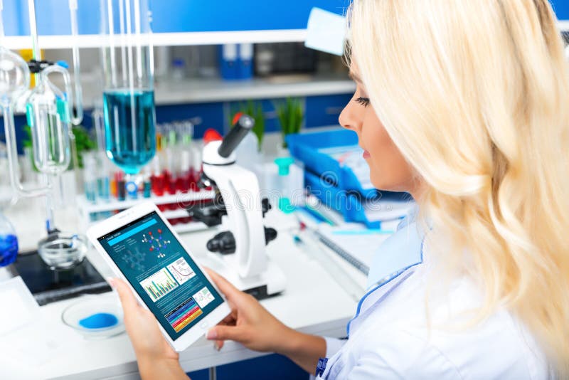 Young Attractive Woman Scientist Using Tablet Computer in the La Stock ... Young Attractive Woman Scientist Using Tablet Computer in the La Stock ...