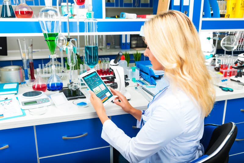 Young Attractive Woman Scientist Using Tablet Computer in the La Stock ... Young Attractive Woman Scientist Using Tablet Computer in the La Stock ...