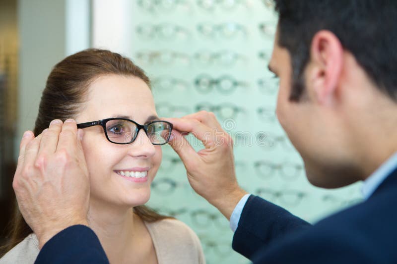Young Attractive Woman Testing New Glasses with Optician Stock Photo ...