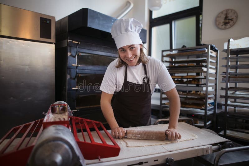 Young Baker with Chef Cap Preparing Pastries in Bakery. Stock Image ...