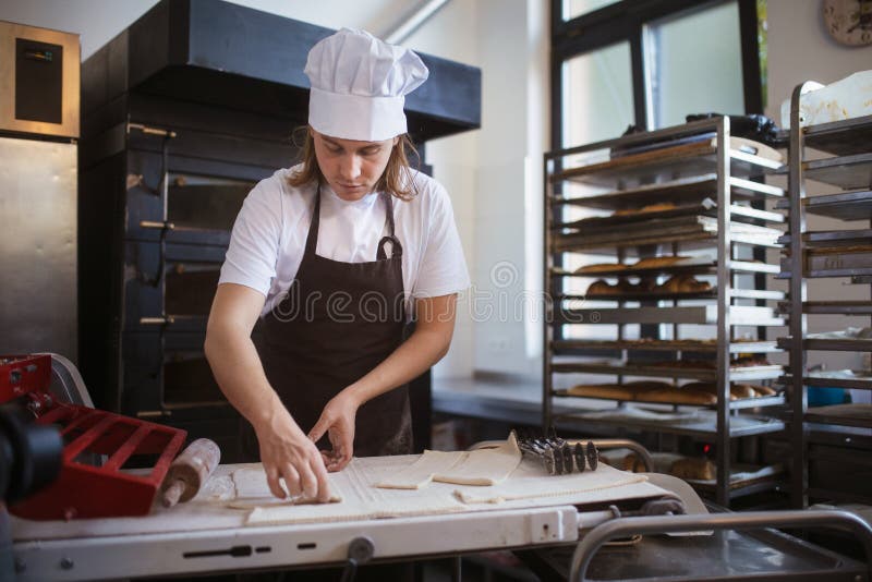 Young Baker with Chef Cap Preparing Pastries in Bakery. Stock Image ...