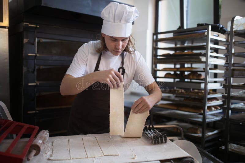 Young Baker with Chef Cap Preparing Pastries in Bakery. Stock Image ...