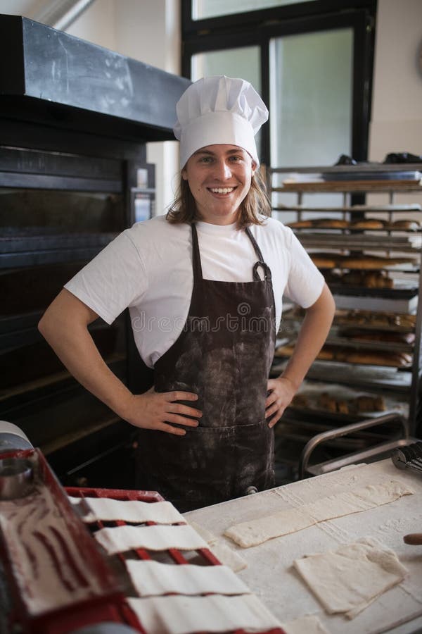 Young Baker with Down Syndrome Preparing Pastries in Bakery. Concept of ...