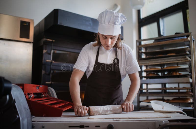 Young Baker Preparing Pastries in the Bakery. Stock Photo - Image of ...