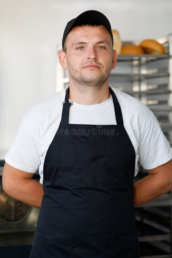 Young Baker Worker in a Bakery in Uniform Stock Image - Image of ...