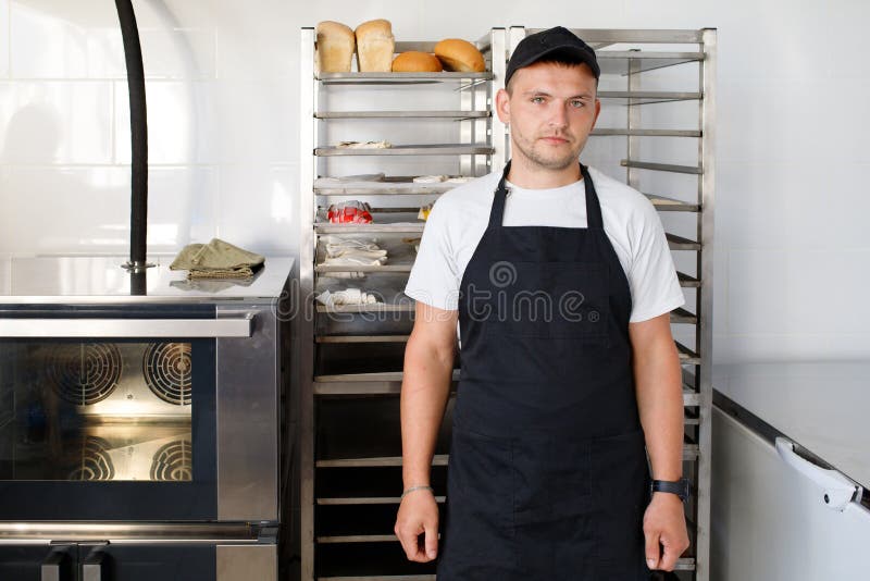 Young Baker Worker in a Bakery in Uniform Stock Photo - Image of fresh ...