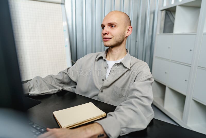 Young Bald Business Man Sitting at Desk in Office, Working on Computer ...