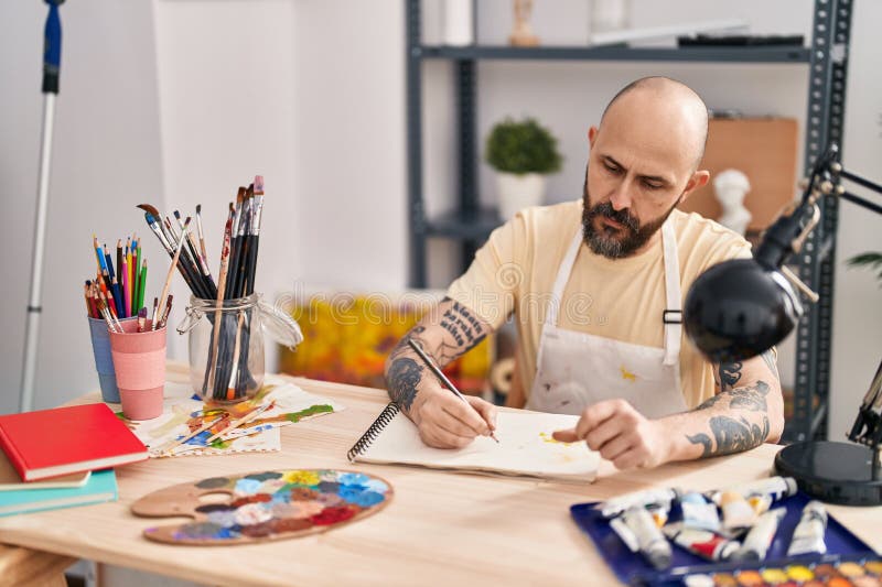 Young Bald Man Artist Drawing on Notebook at Art Studio Stock Photo ...