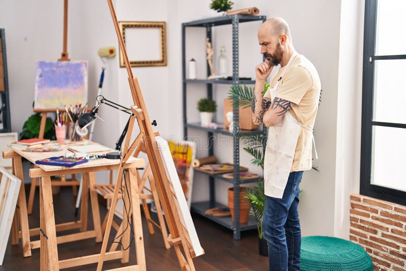 Young Bald Man Artist Looking Draw with Serious Expression at Art ...