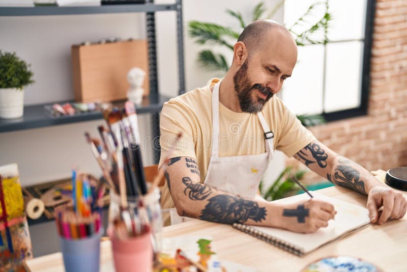 Young Bald Man Artist Smiling Confident Drawing on Notebook at Art ...