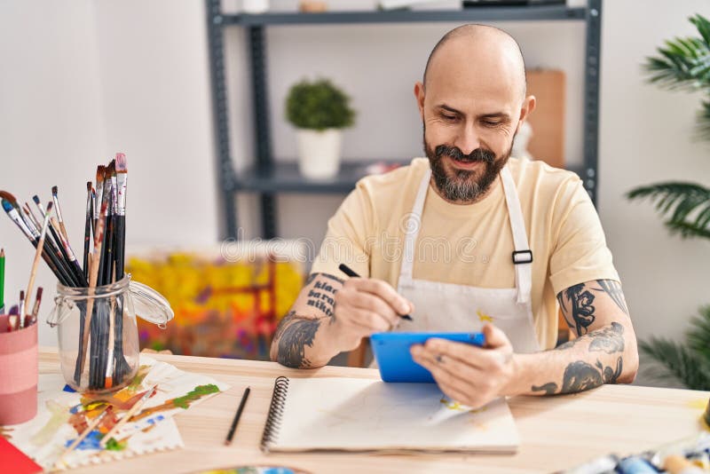 Young Bald Man Artist Smiling Confident Drawing on Touchpad at Art ...