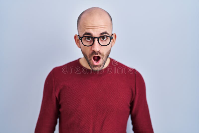 Young Bald Man With Beard Standing Over White Background Wearing