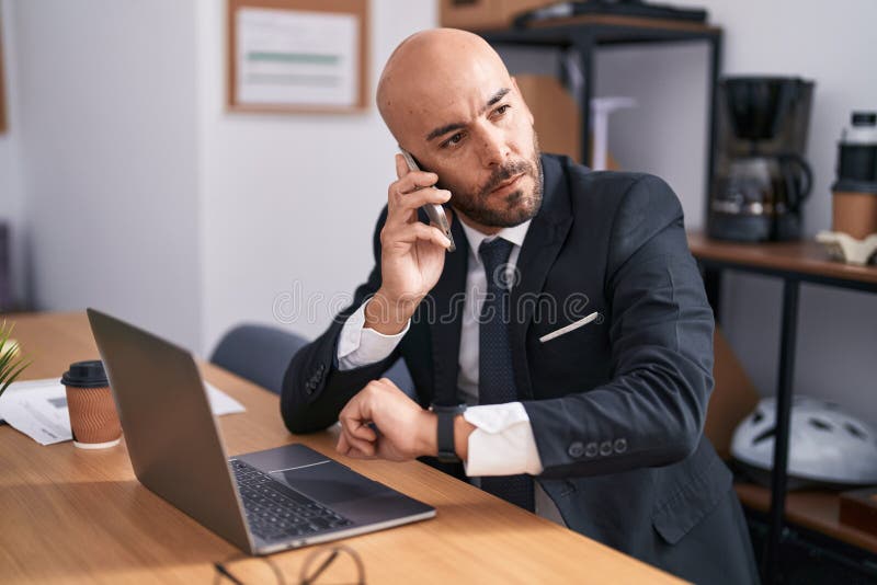 Young Bald Man Business Worker Talking on Smartphone Looking Watch at ...