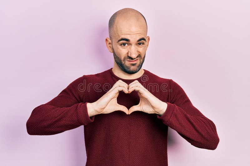 Young Bald Man Doing Heart Symbol with Hands Clueless and Confused ...