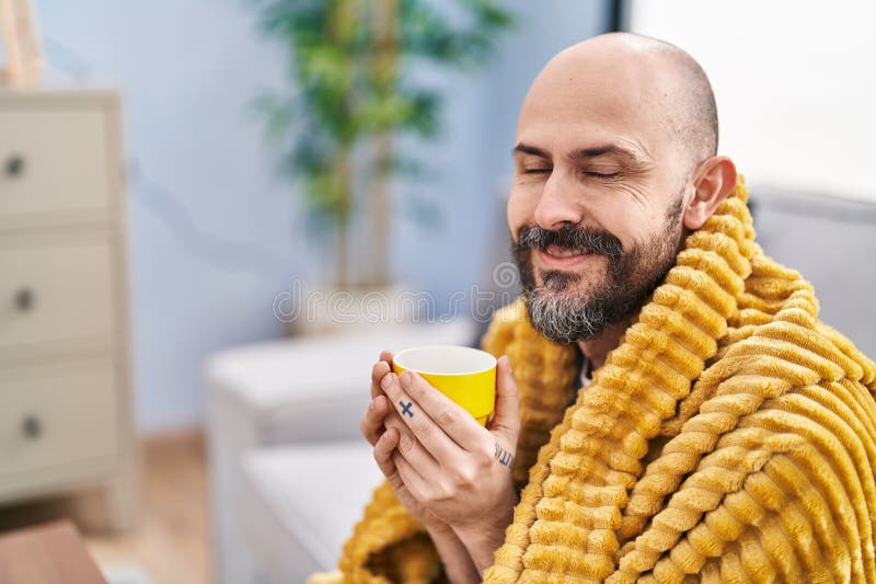 Young Bald Man Drinking Coffee Sitting on Sofa at Home Stock Image ...