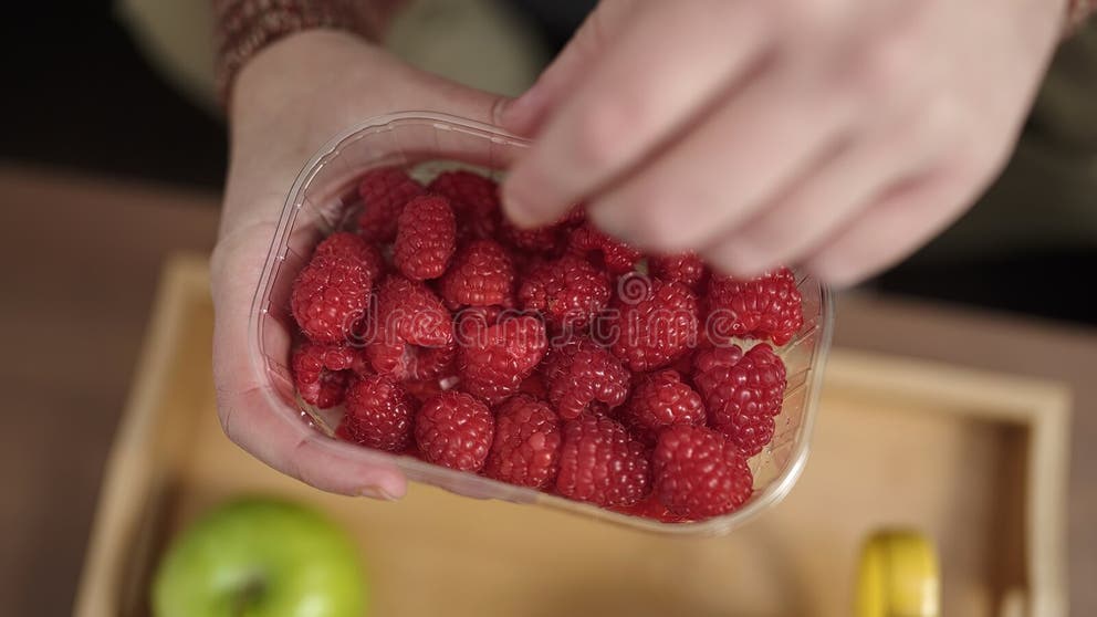 Young Bald Man Holding Raspberry Sitting on Sofa at Home Stock Image ...