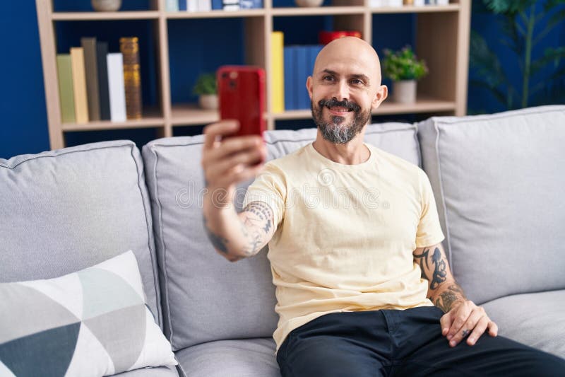 Young Bald Man Make Selfie by Smartphone Sitting on Sofa at Home Stock ...