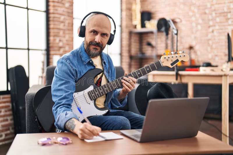 Young Bald Man Musician Composing Song at Music Studio Stock Photo ...
