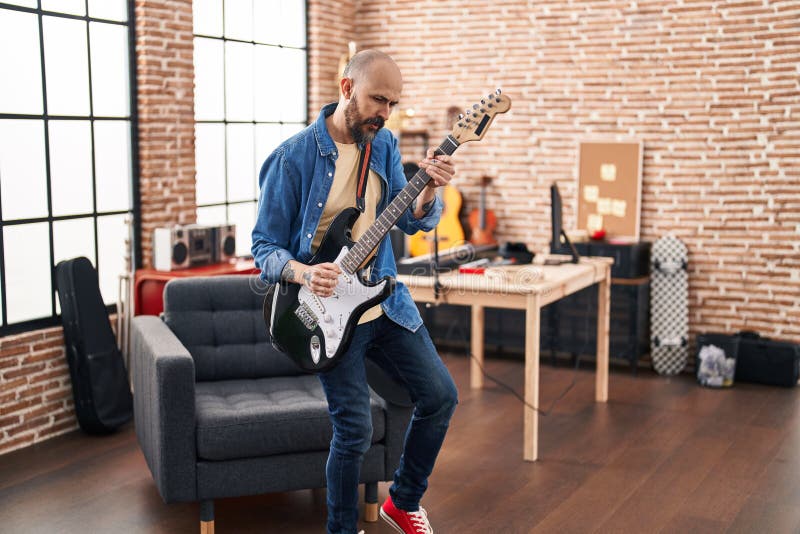 Young Bald Man Musician Playing Electrical Guitar Standing at Music ...