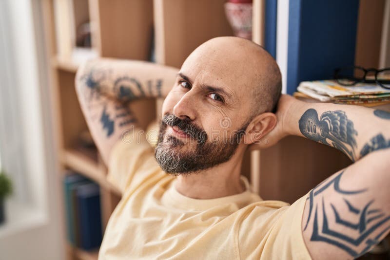 Young Bald Man Relaxed with Hands on Head Sitting on Sofa at Home Stock ...