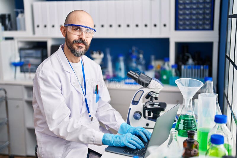 Young Bald Man Scientist Using Laptop at Laboratory Stock Photo - Image ...