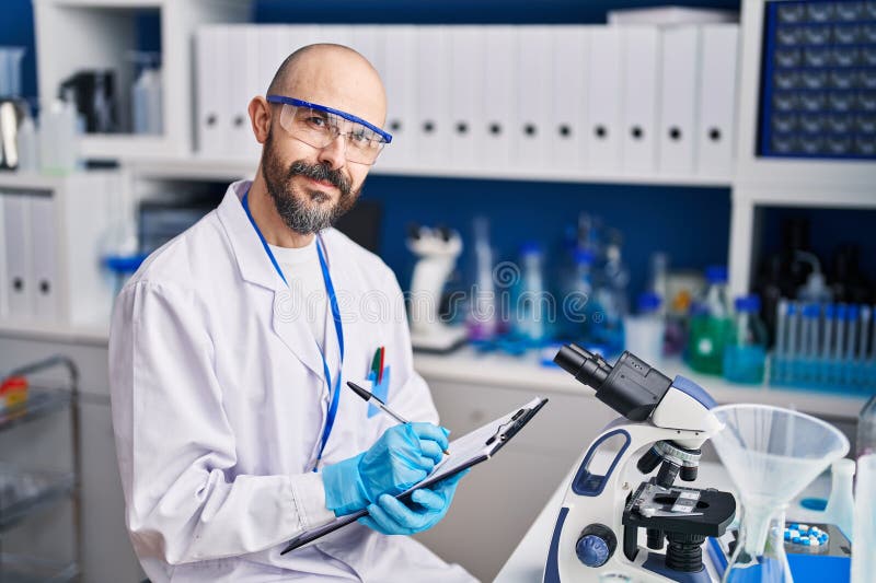 Young Bald Man Scientist Writing Report Working at Laboratory Stock ...