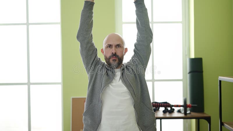 Young Bald Man Standing with Relaxed Expression Stretching Arms at ...