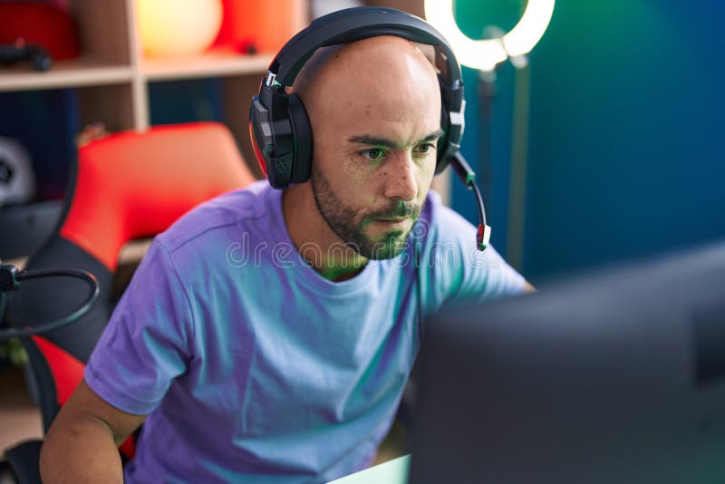 Young Bald Man Streamer Playing Video Game Using Computer at Gaming ...