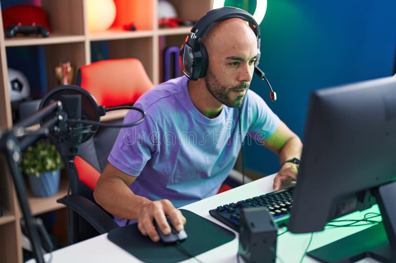 Young Bald Man Streamer Playing Video Game Using Computer at Gaming ...