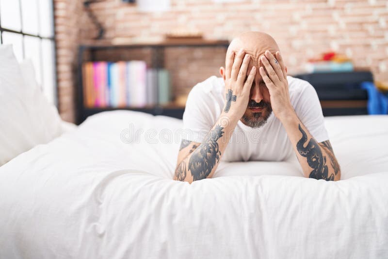 Young Bald Man Stressed Lying on Bed at Bedroom Stock Image - Image of ...