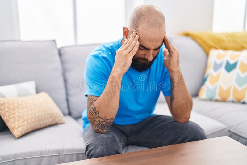 Young Bald Man Stressed Sitting on Sofa at Home Stock Image - Image of ...