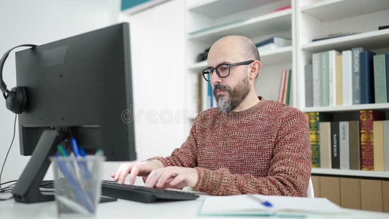 Young Bald Man Student Using Computer Studying at University Classroom ...
