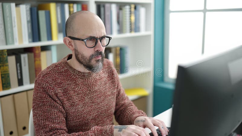 Young Bald Man Student Using Computer Studying at University Classroom ...