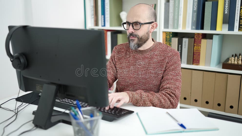 Young Bald Man Student Using Computer Studying at University Classroom ...