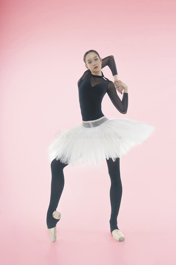 Ballerina in a Black Tutu is Leaning Forward with Her Arms Crossed ...