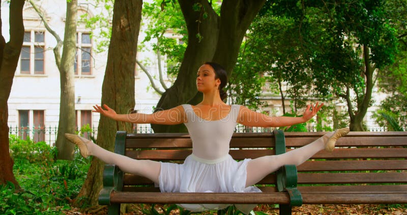Young Ballerina Practicing Ballet Dance on Bench in the Park 4k Stock ...