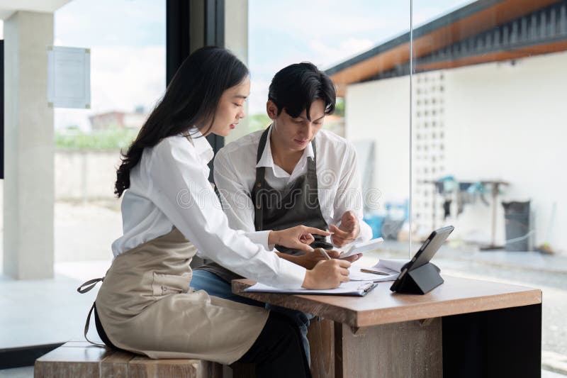 Young Baristas Collaborating on Coffee Shop Business Plan with Digital ...