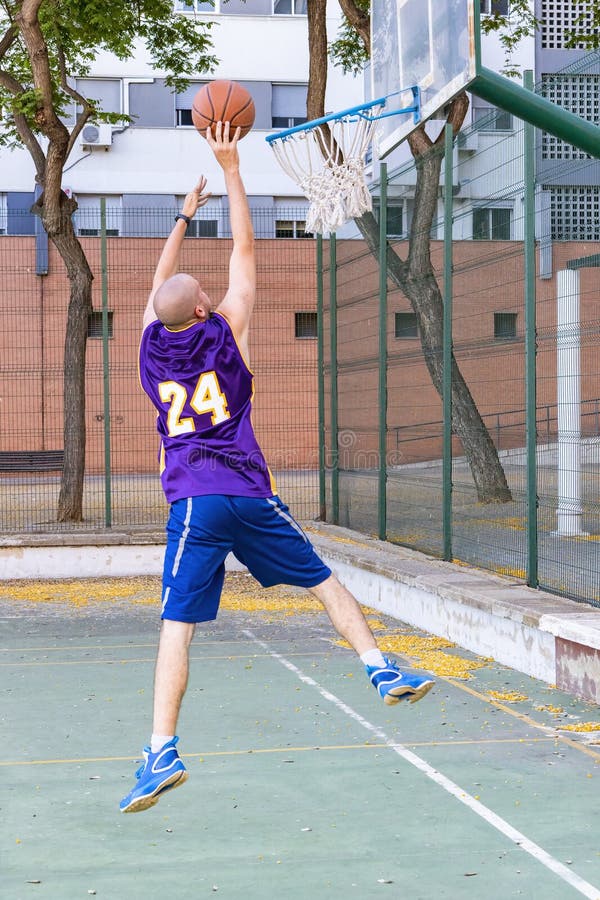 A Young Basketball Player Shooting a Basketball Stock Photo - Image of ...