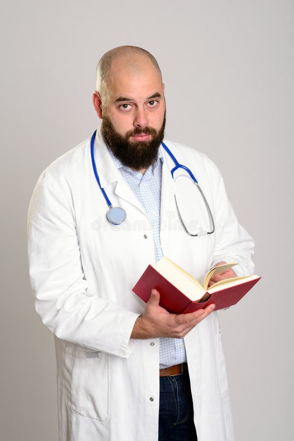Young Bearded Doctor with Book Stock Photo - Image of occupation, coat ...
