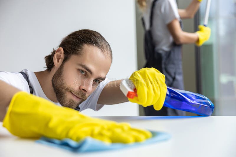 Young Bearded Service Man Looking Busy while Cleaning the Office Stock ...