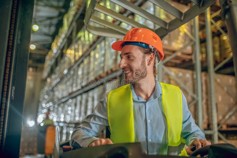 Young Bearded Worker Smiling and Looking Aside Stock Photo - Image of ...
