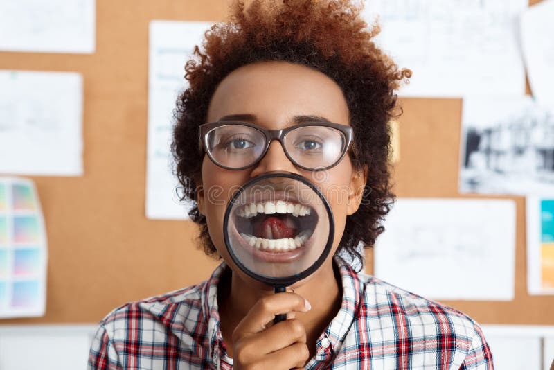Young Beautiful African Worker Holding Magnifier Infront of Mouth ...