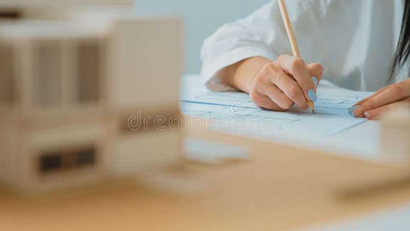 Young Beautiful Architect Hand Drawing Blueprint at Modern Office ...