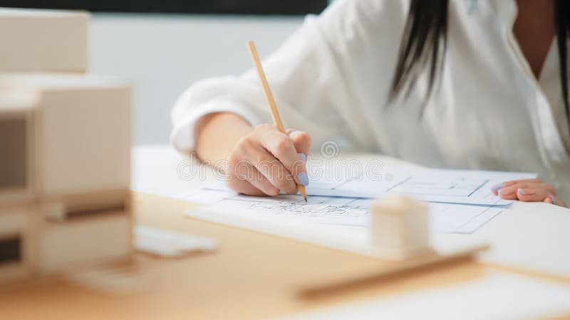 Young Beautiful Architect Hand Drawing Blueprint at Modern Office ...
